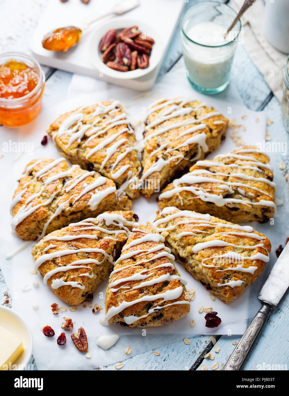 Scones with oats, cranberry and pecan nuts on wooden background. Top ...