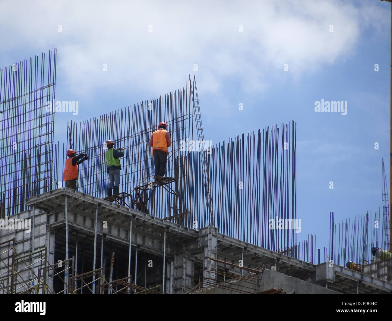 Construction workers installing reinforcement bar at the construction ...