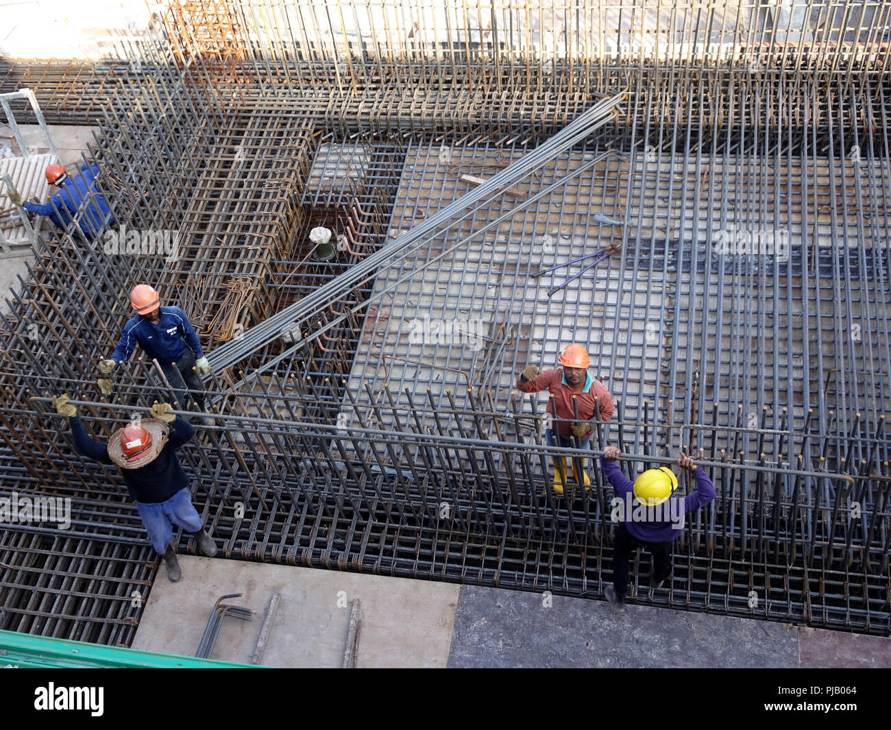Construction workers installing reinforcement bar at the construction ...