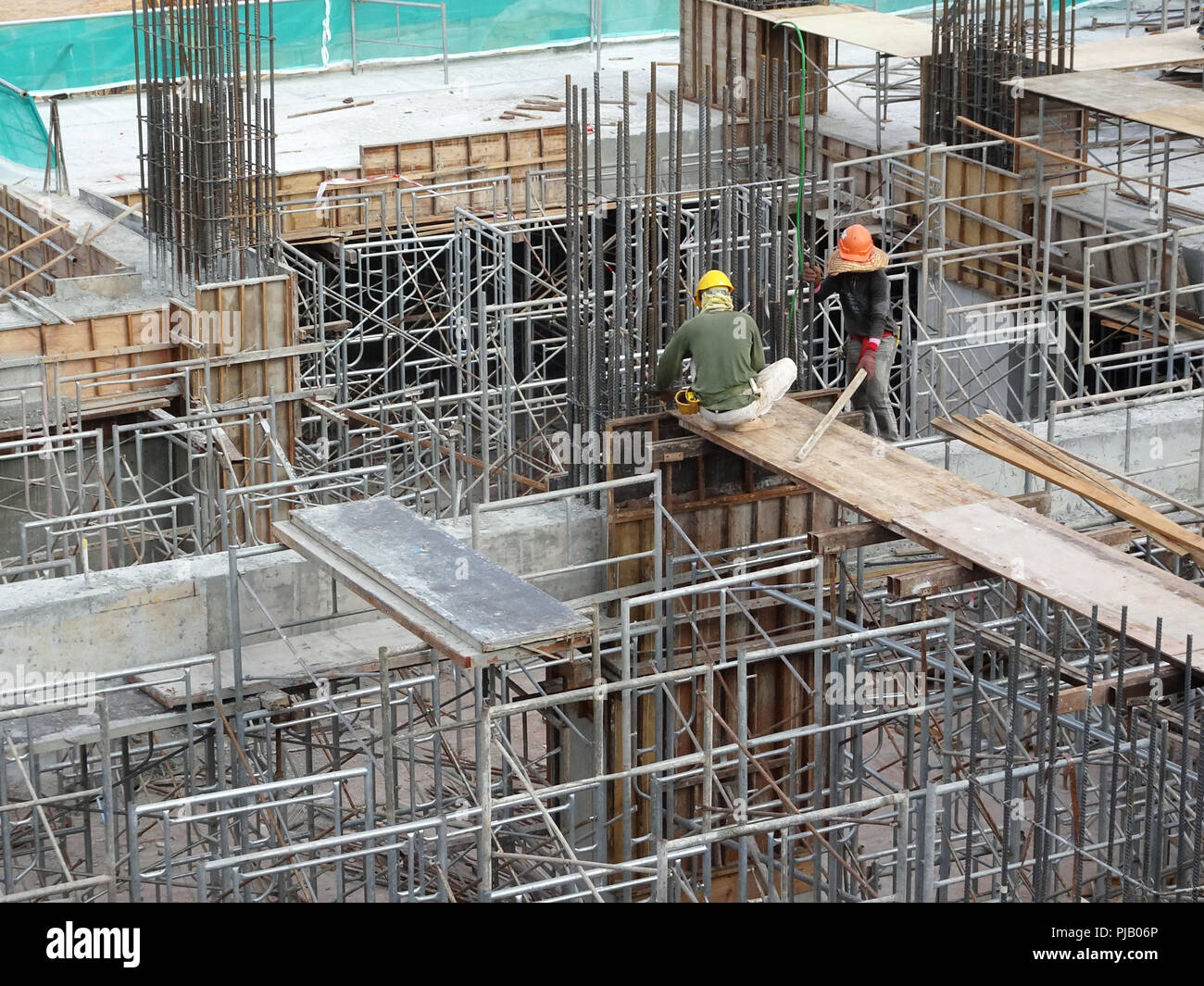 Construction workers installing reinforcement bar at the construction ...