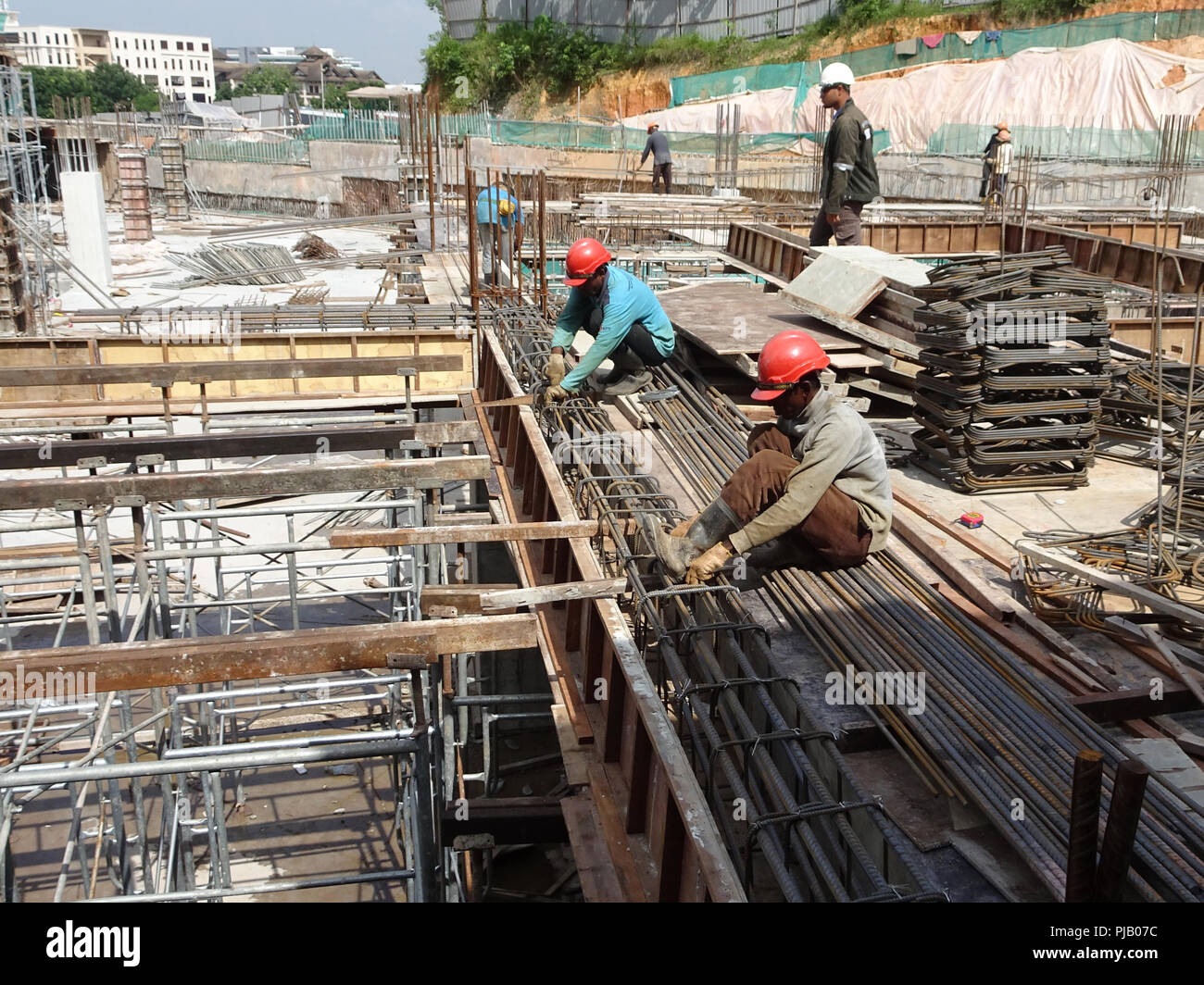 Construction workers installing reinforcement bar at the construction ...