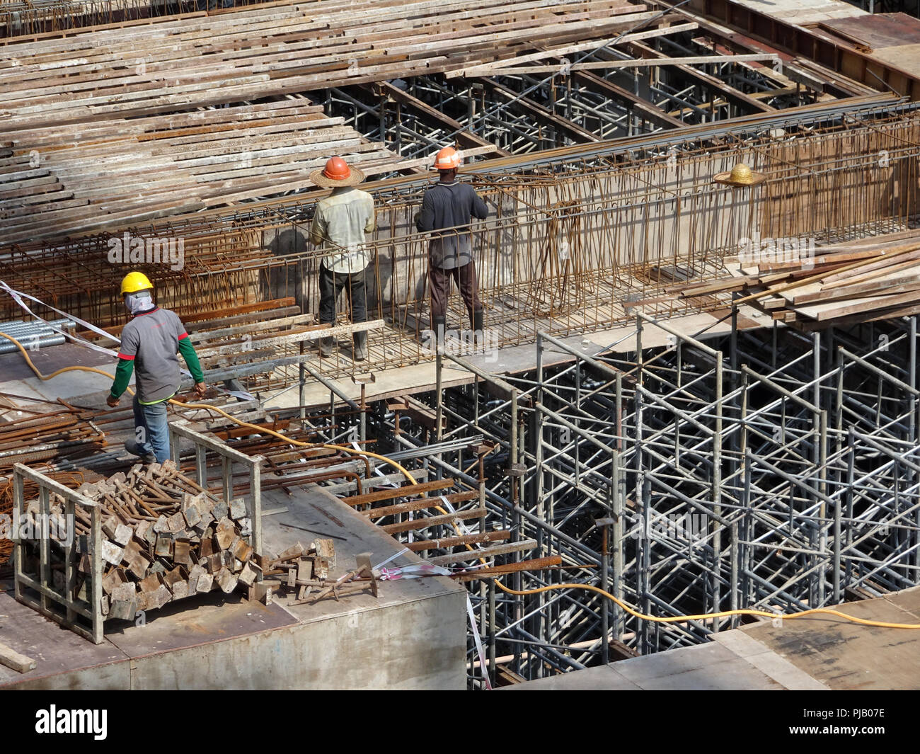 Construction workers installing reinforcement bar at the construction ...