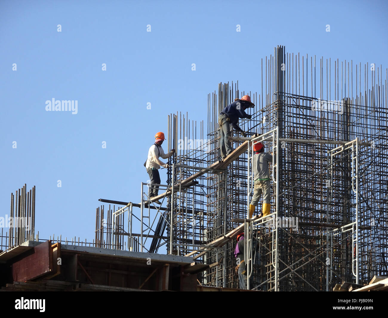 Construction workers installing reinforcement bar at the construction ...