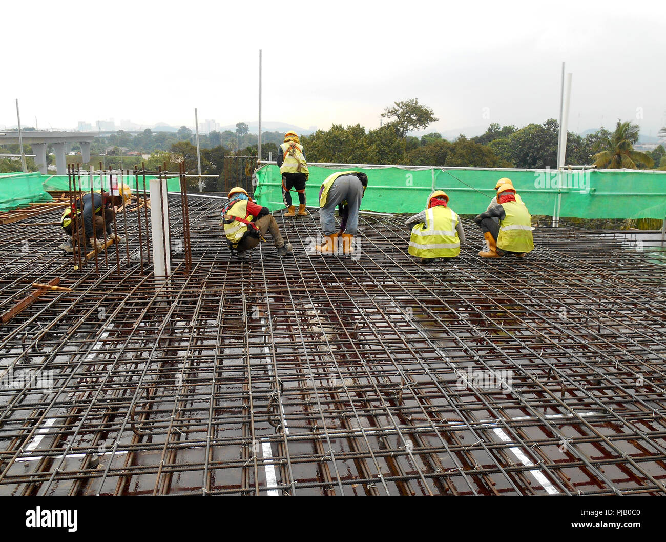 Construction workers installing reinforcement bar at the construction ...