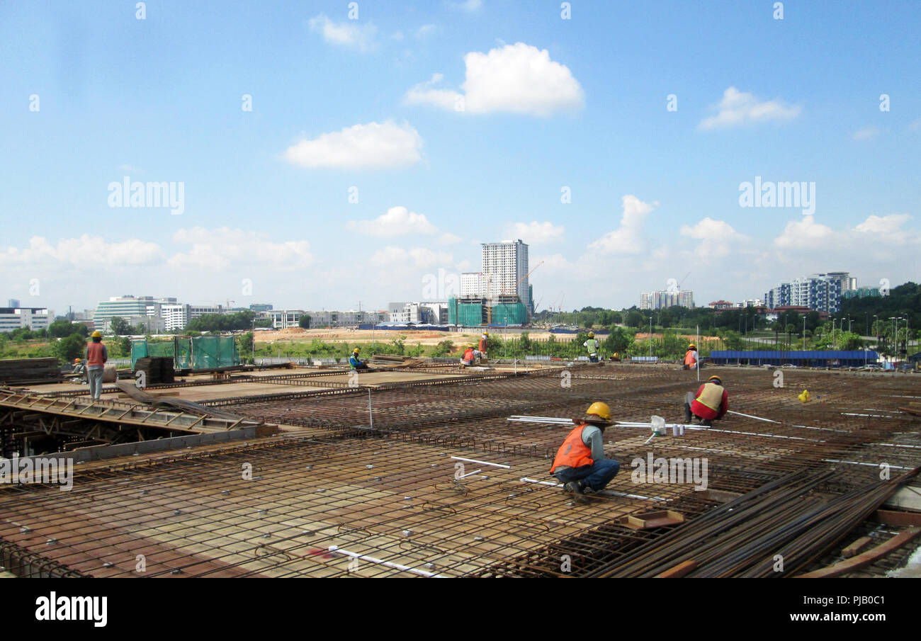 Construction workers installing reinforcement bar at the construction ...