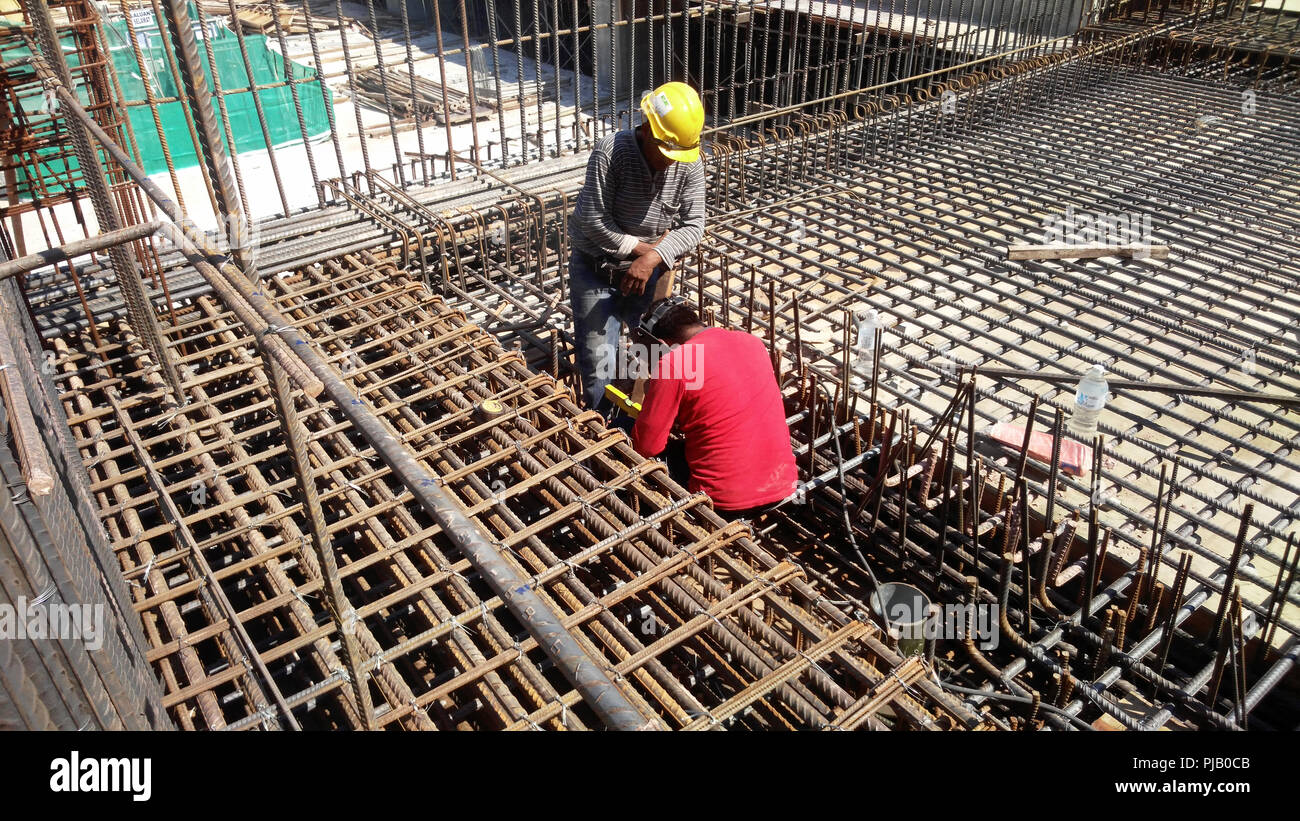 Construction workers installing reinforcement bar at the construction ...
