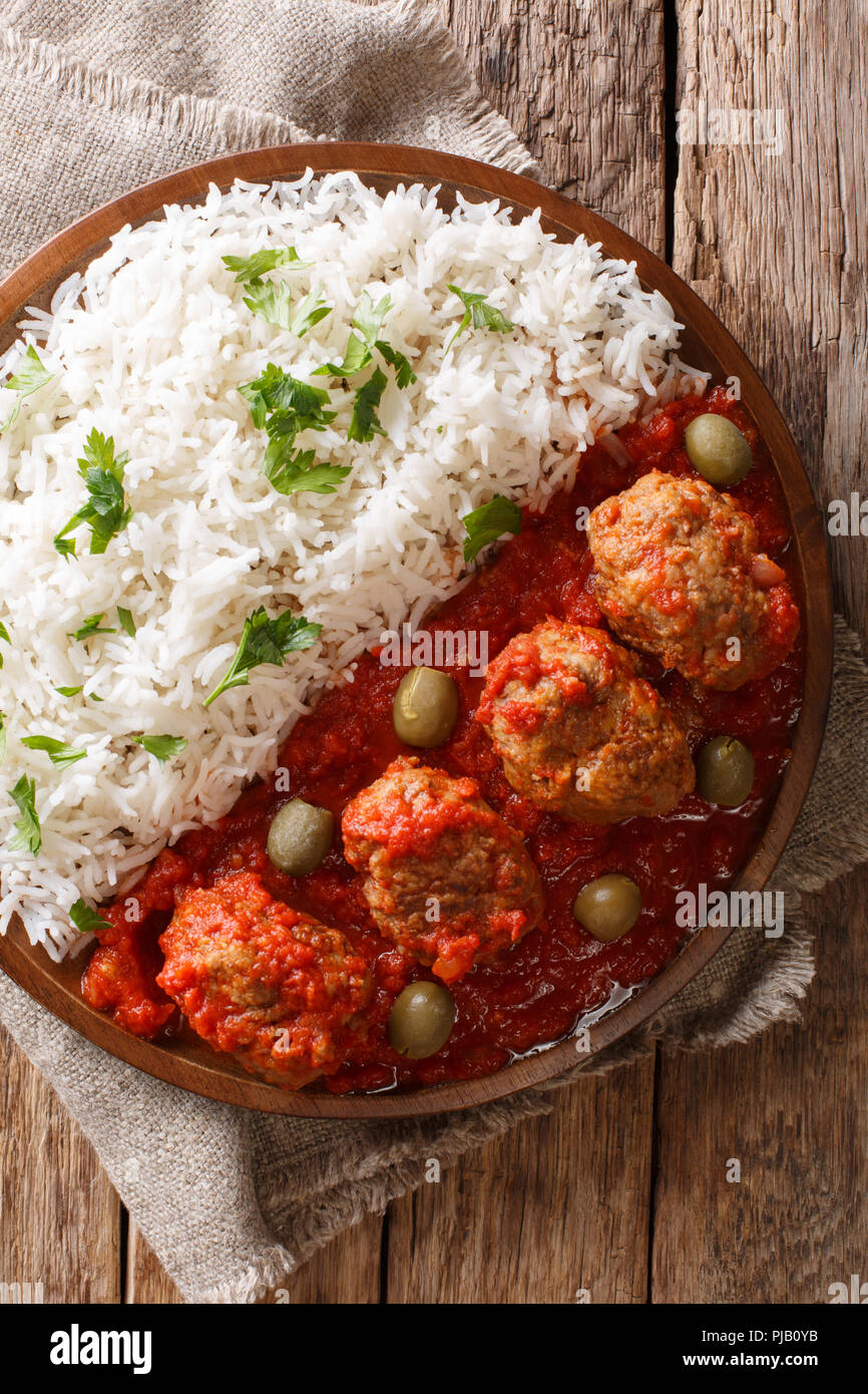 Traditional Greek meatballs in tomato sauce with rice close-up on a ...