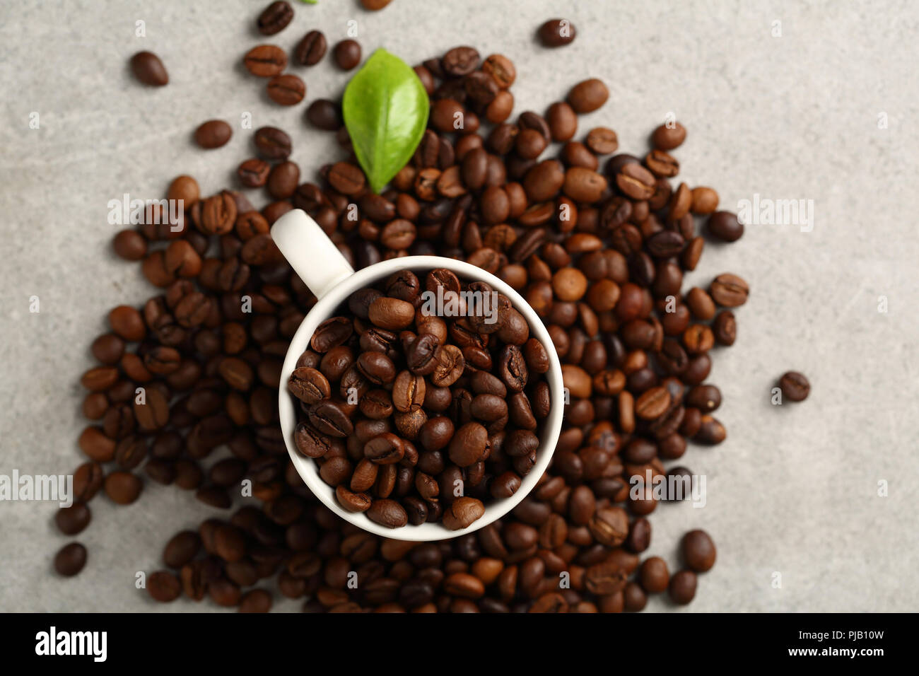 Coffee beans in cup concepts Stock Photo - Alamy