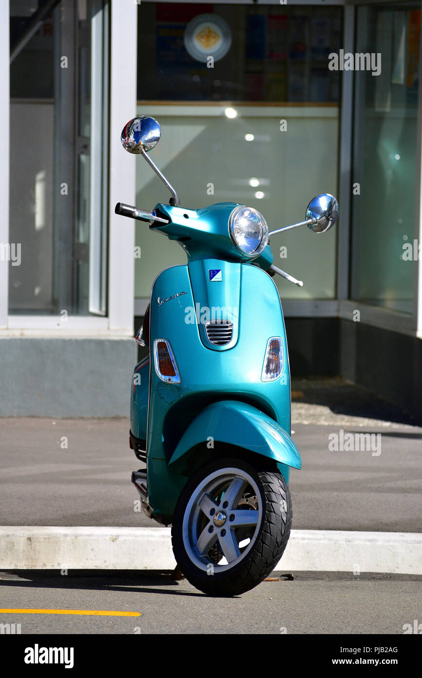 A shiny teal vespa scooter Stock Photo - Alamy
