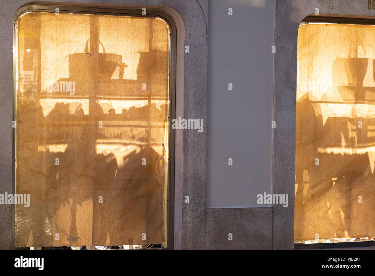 Shadows in a shop window cast by display stands and clothing Stock ...