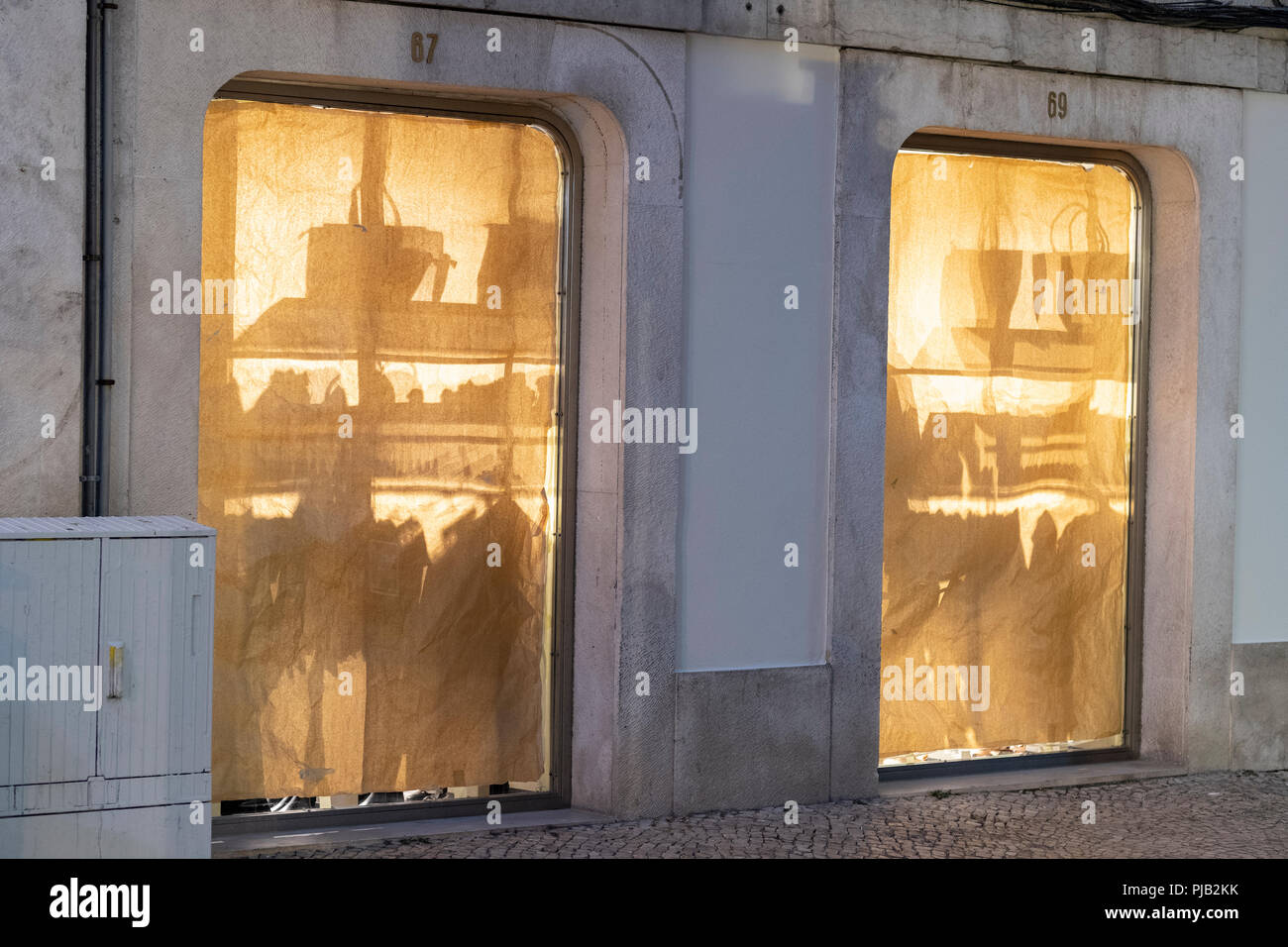 Shadows in a shop window cast by display stands and clothing Stock ...