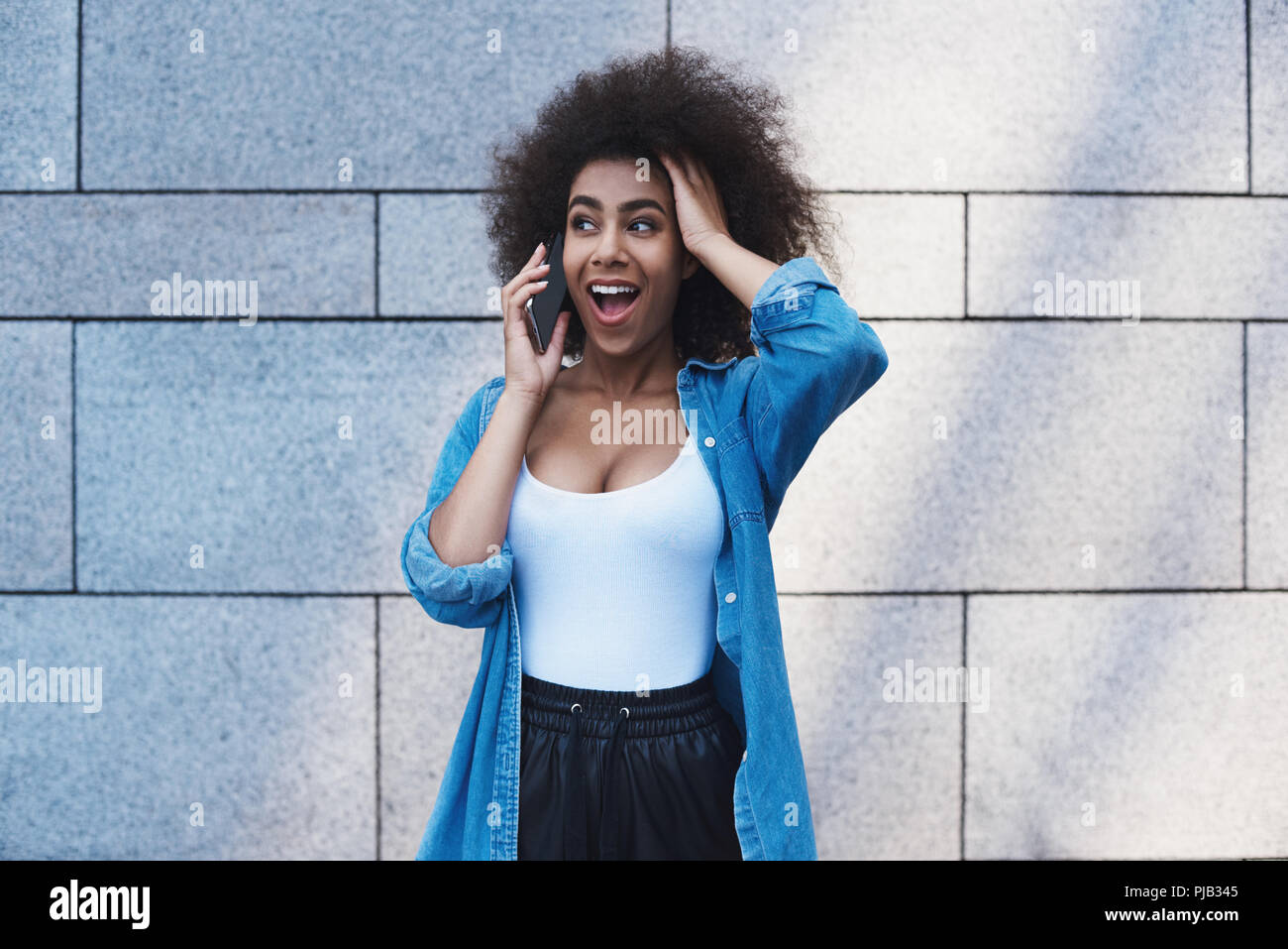 Young woman wearing jeans jacket free style on the street standing ...