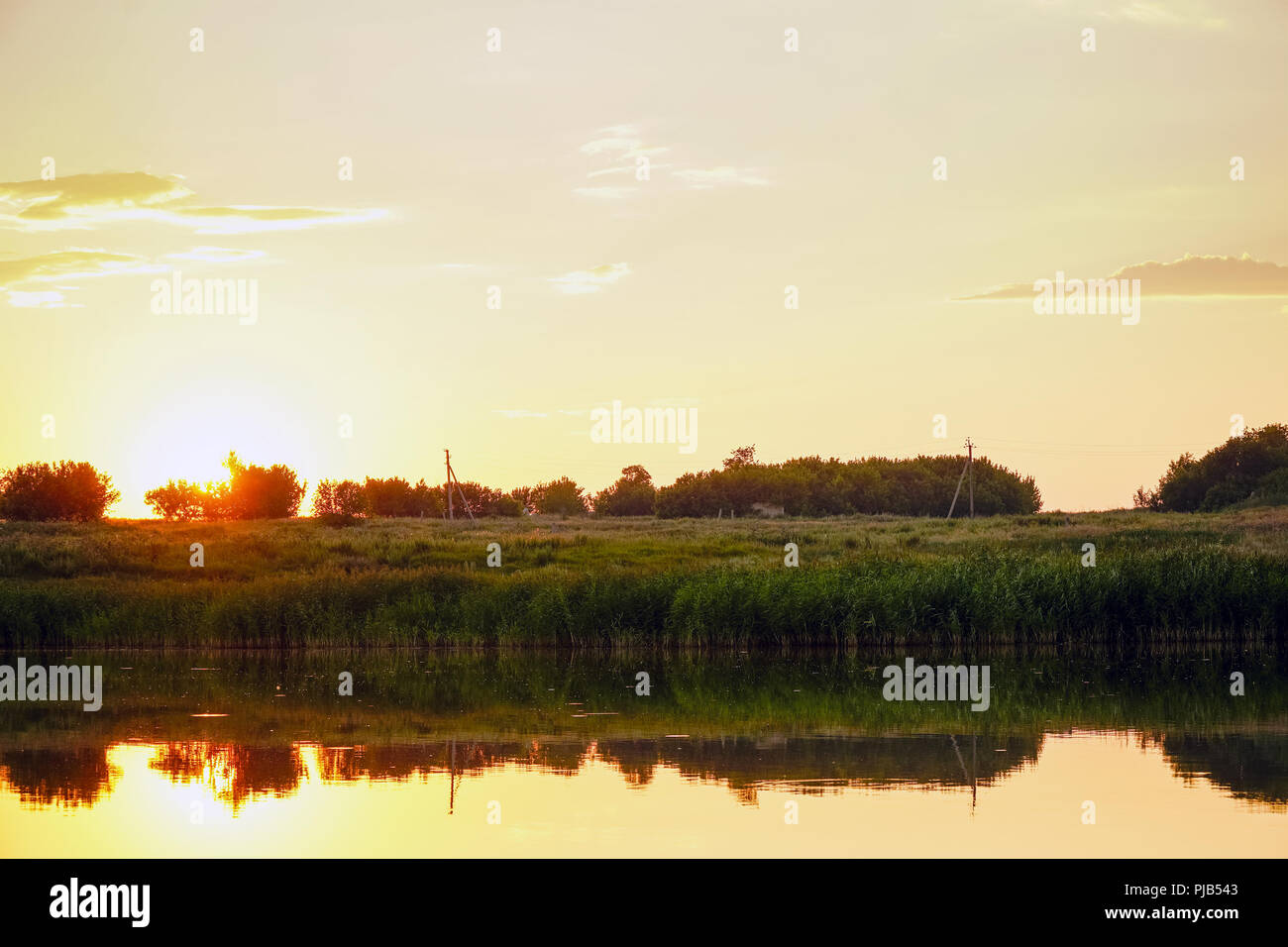 Beautiful summer sunset on small lake Stock Photo - Alamy