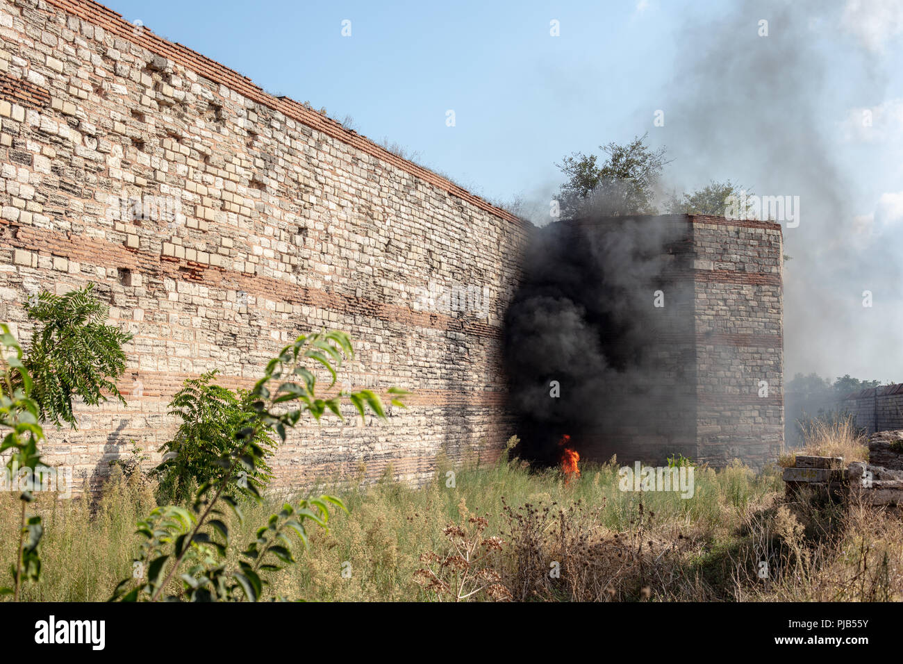 A fire and smoke near the ruins of the walls of Constantinople. (today ...