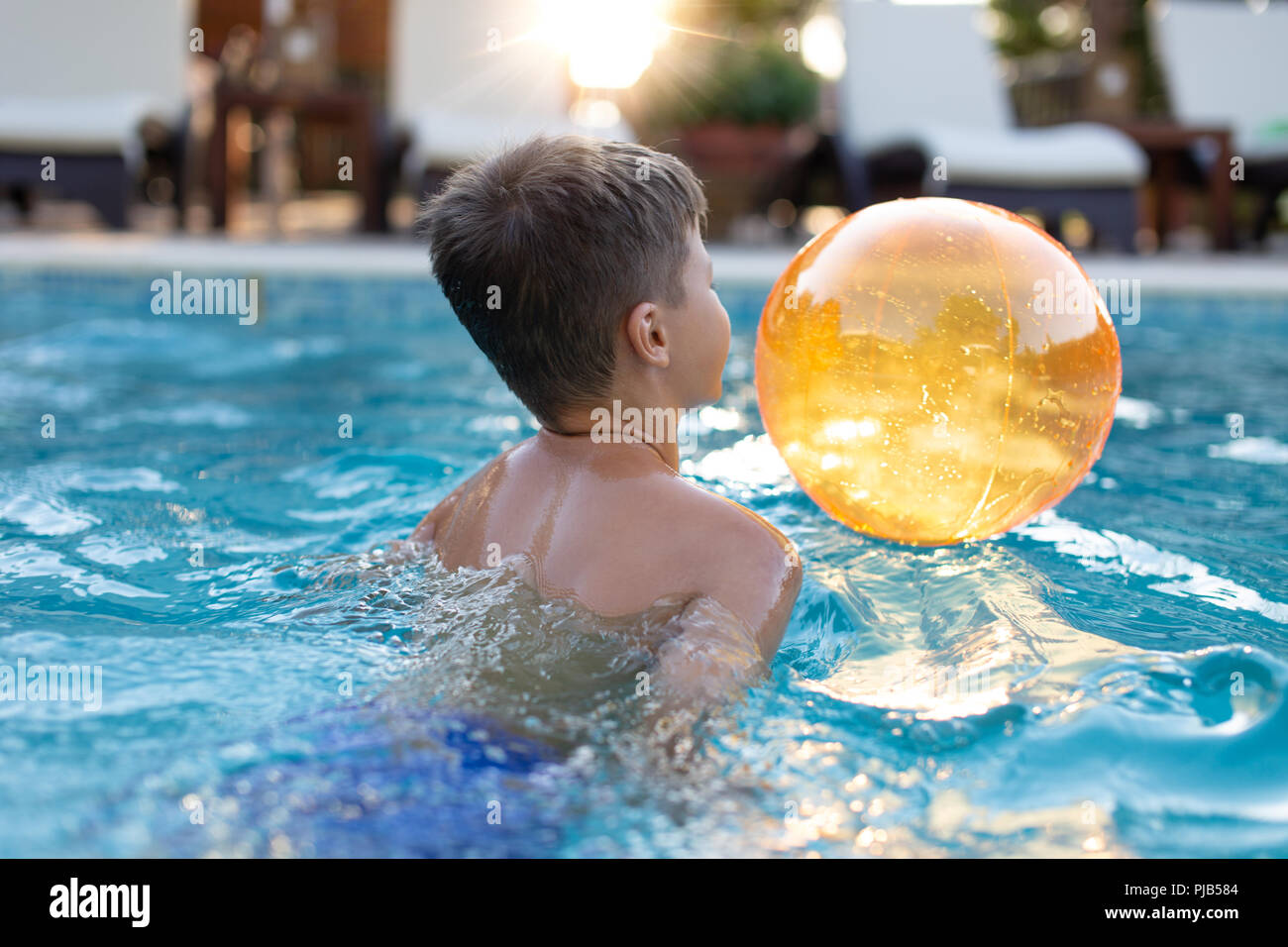 Playing ball swimming pool hi-res stock photography and images - Alamy