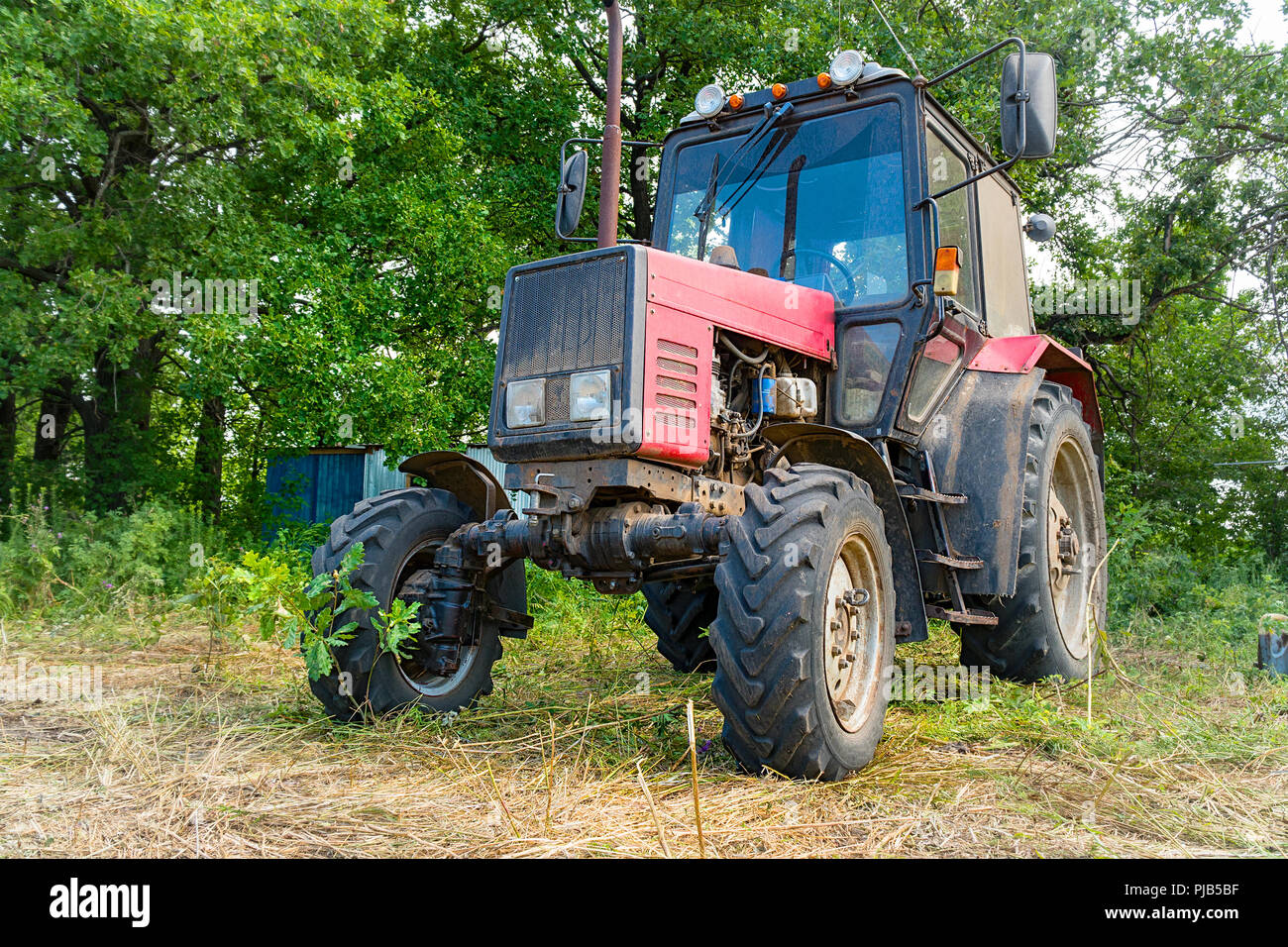 Tractor for working in the field and mowing grass Stock Photo - Alamy