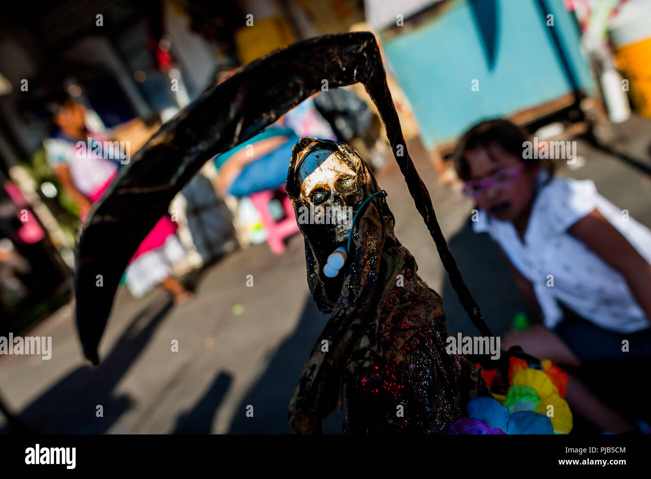A statue of Santa Muerte (Holy Death), holding a large scythe, is seen ...