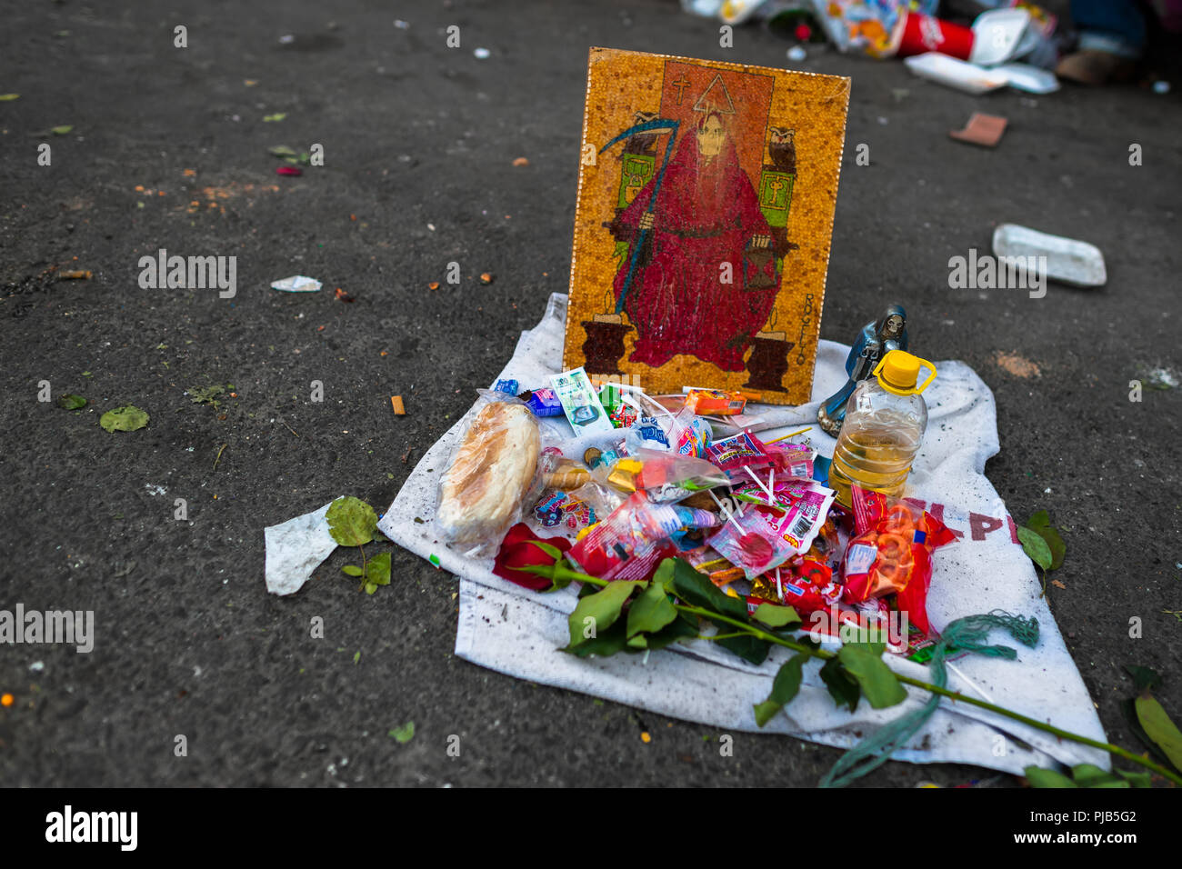 An altar of Santa Muerte (Holy Death), surrounded by offerings, is seen ...