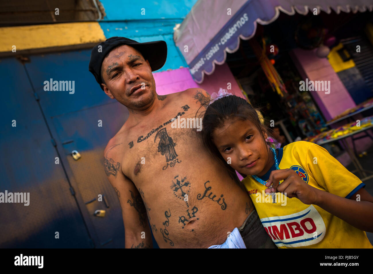 A Mexiacn girl shows a protective Santa Muerte (Holy Death) amulet ...