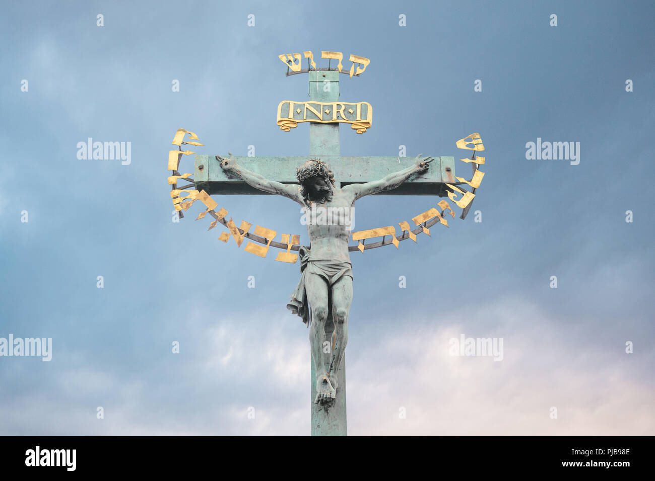 The statue of Jesus Christ on the Charles Bridge in Prague in the Czech ...