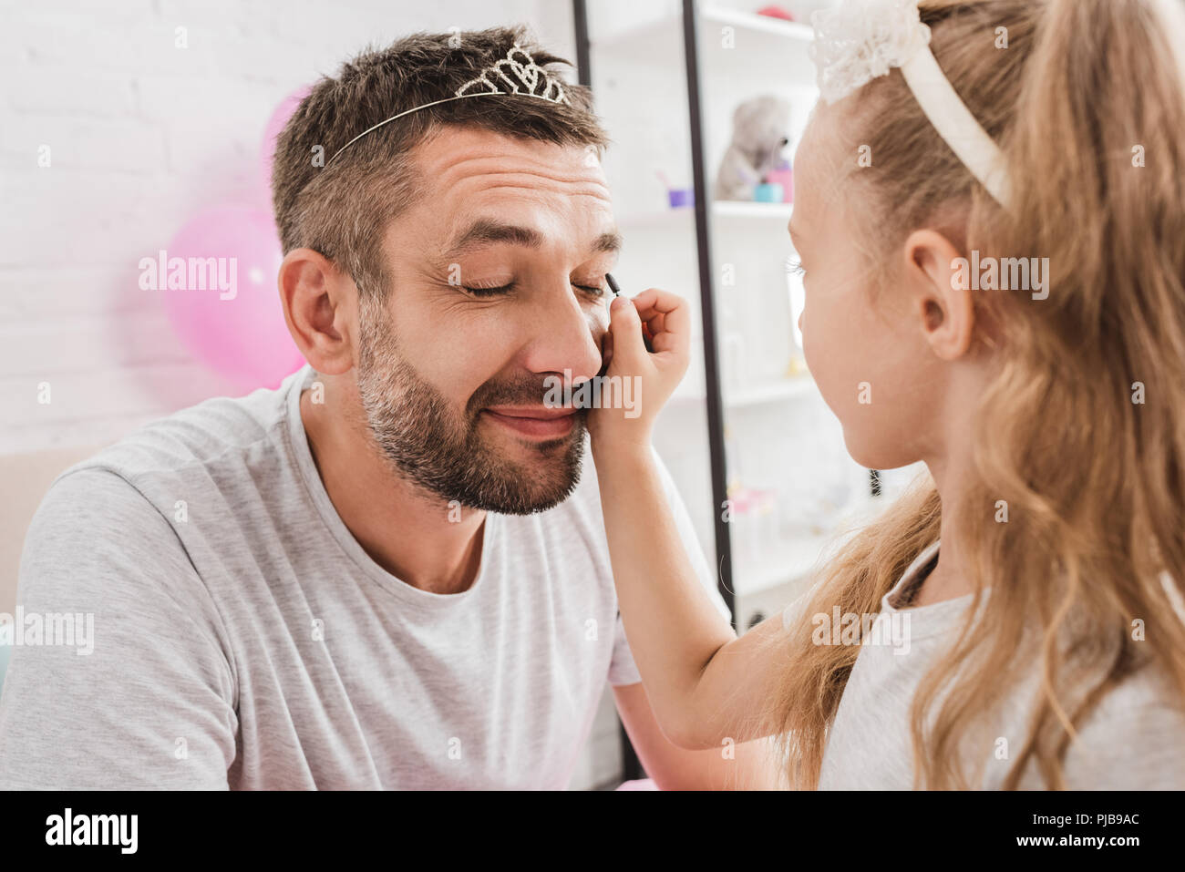 side view of daughter doing makeup to father Stock Photo - Alamy