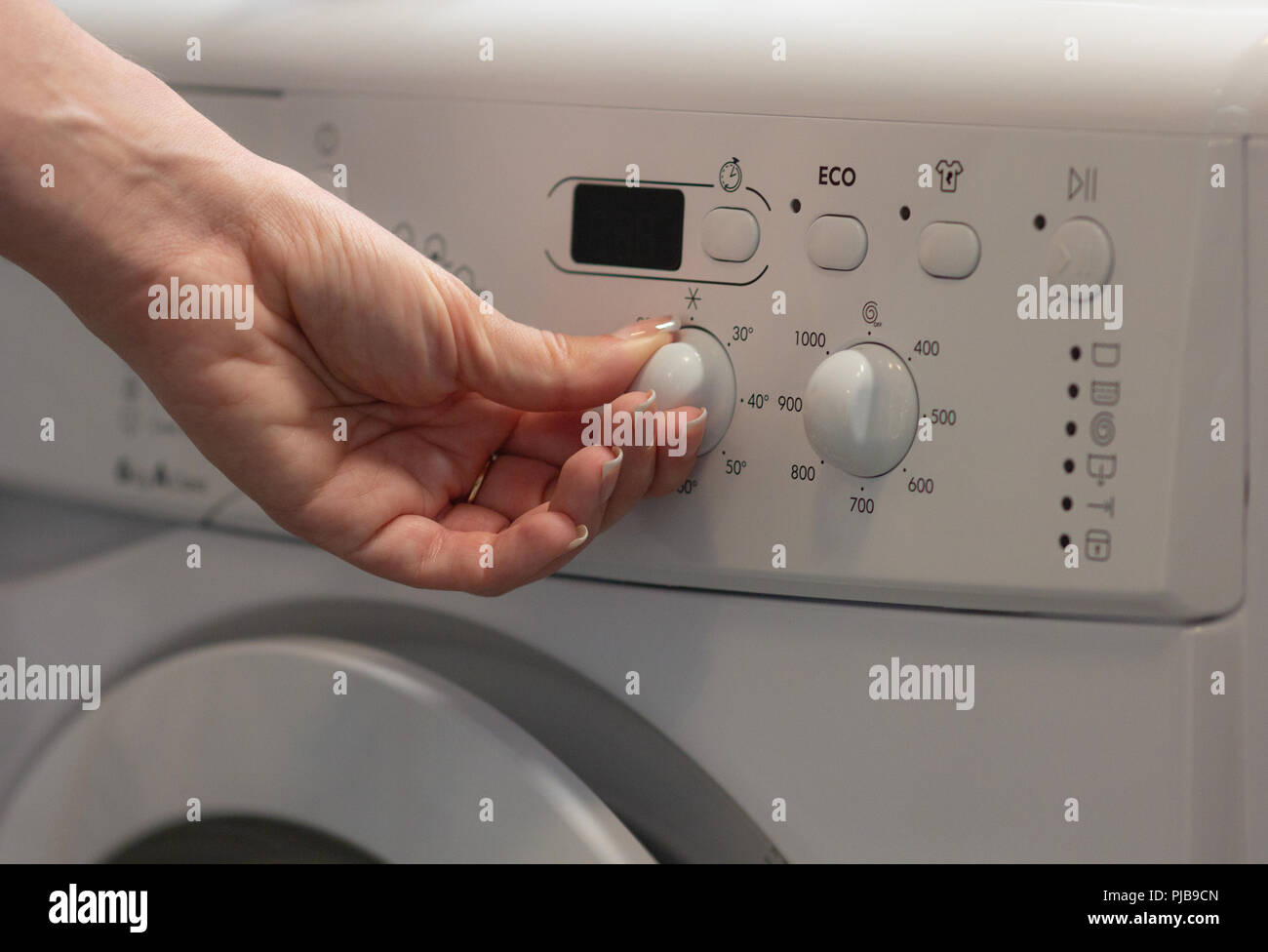 Temperature switch in a white washing machine Stock Photo - Alamy