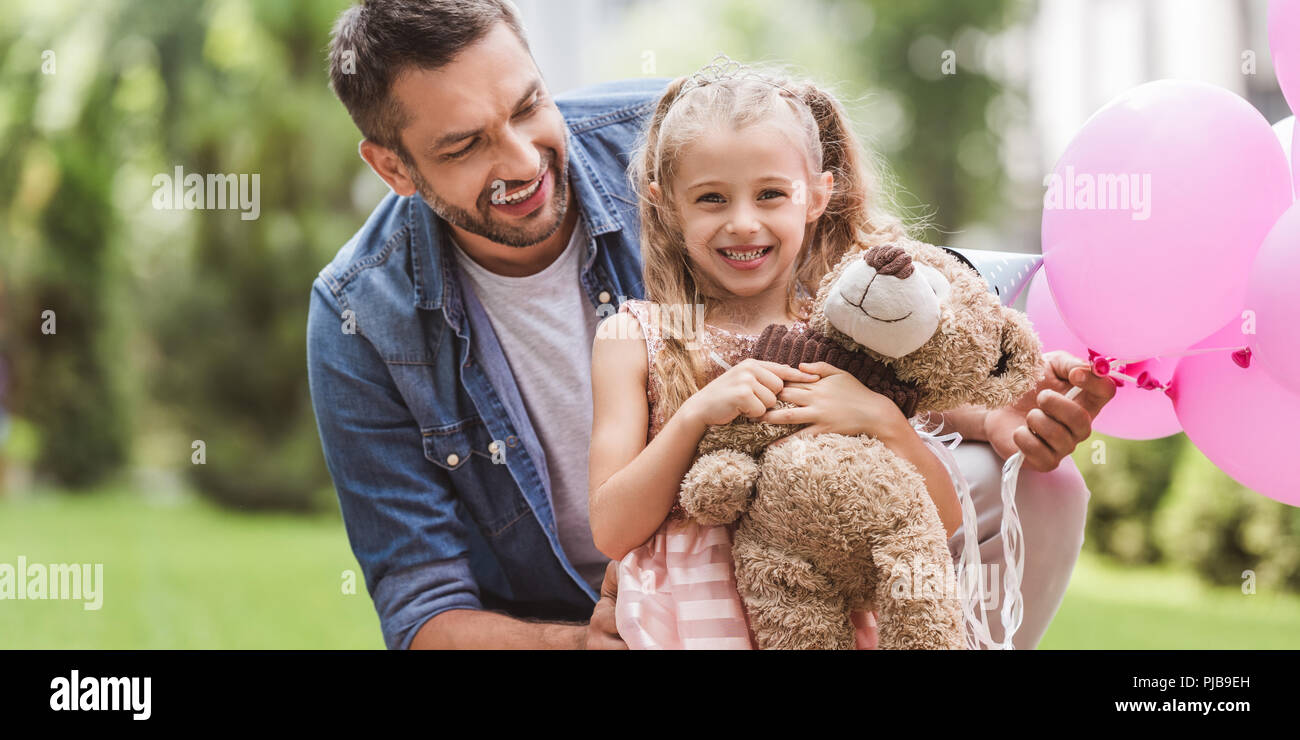 father and daughter with teddy bear at lawn Stock Photo - Alamy