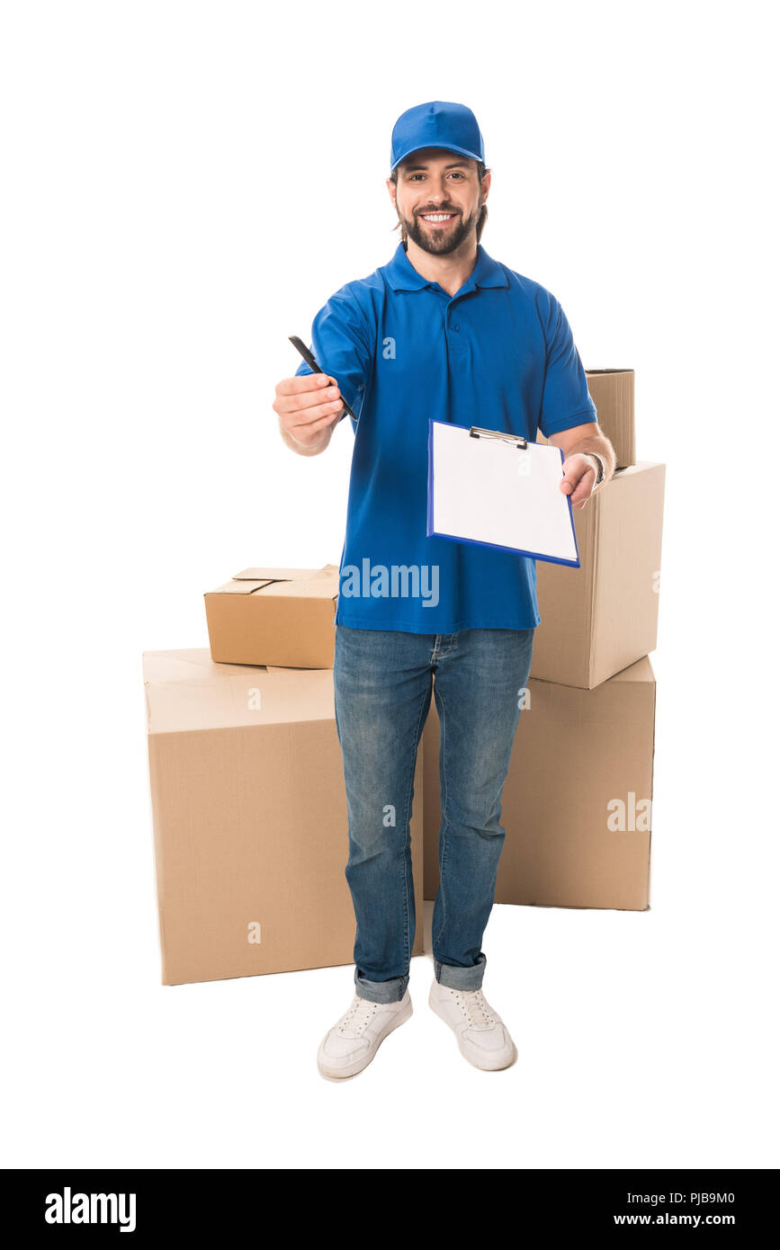 happy young delivery man holding clipboard and smiling at camera ...