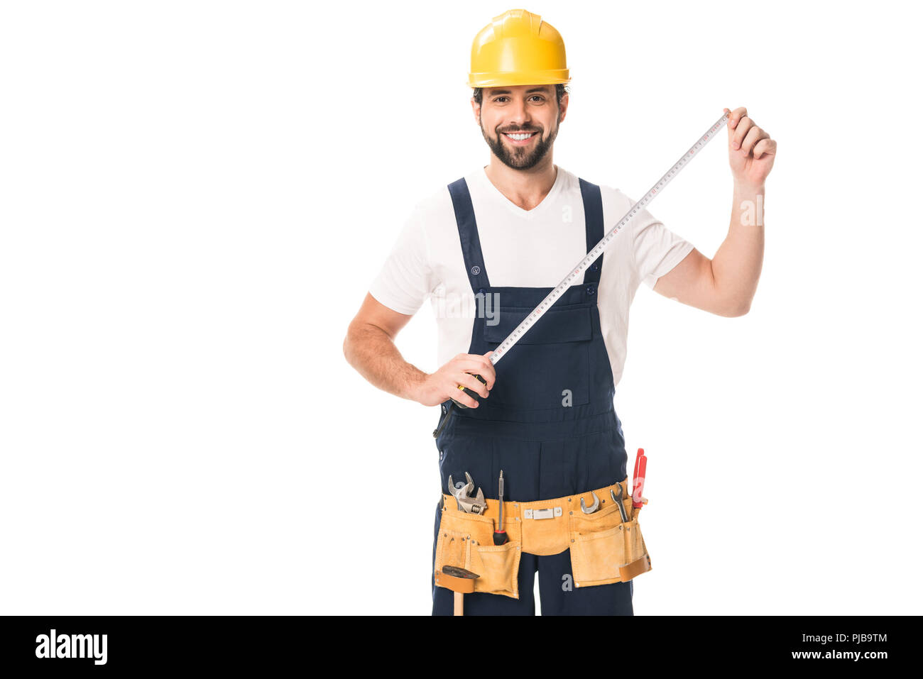 handsome happy workman holding measuring tape and smiling at camera ...