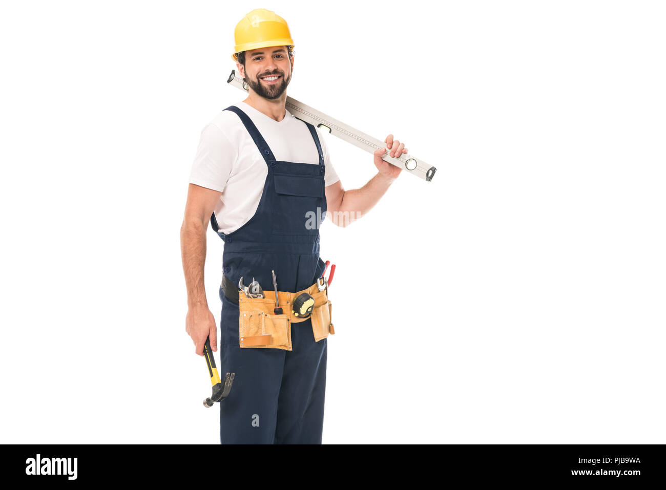 handsome happy workman holding level tool and hammer, smiling at camera ...