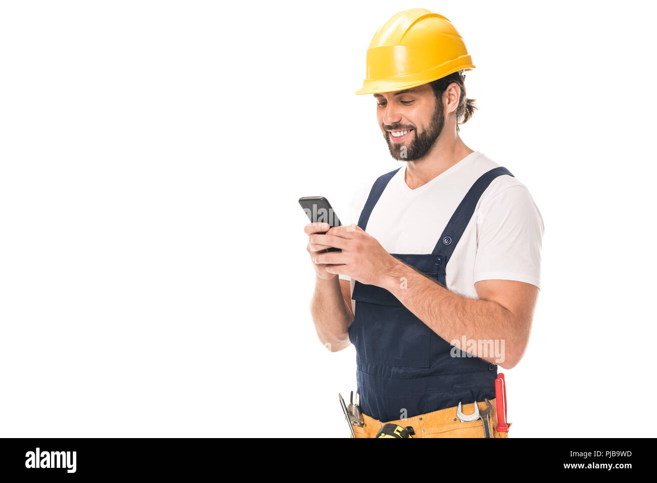happy workman in hard hat using smartphone isolated on white Stock ...
