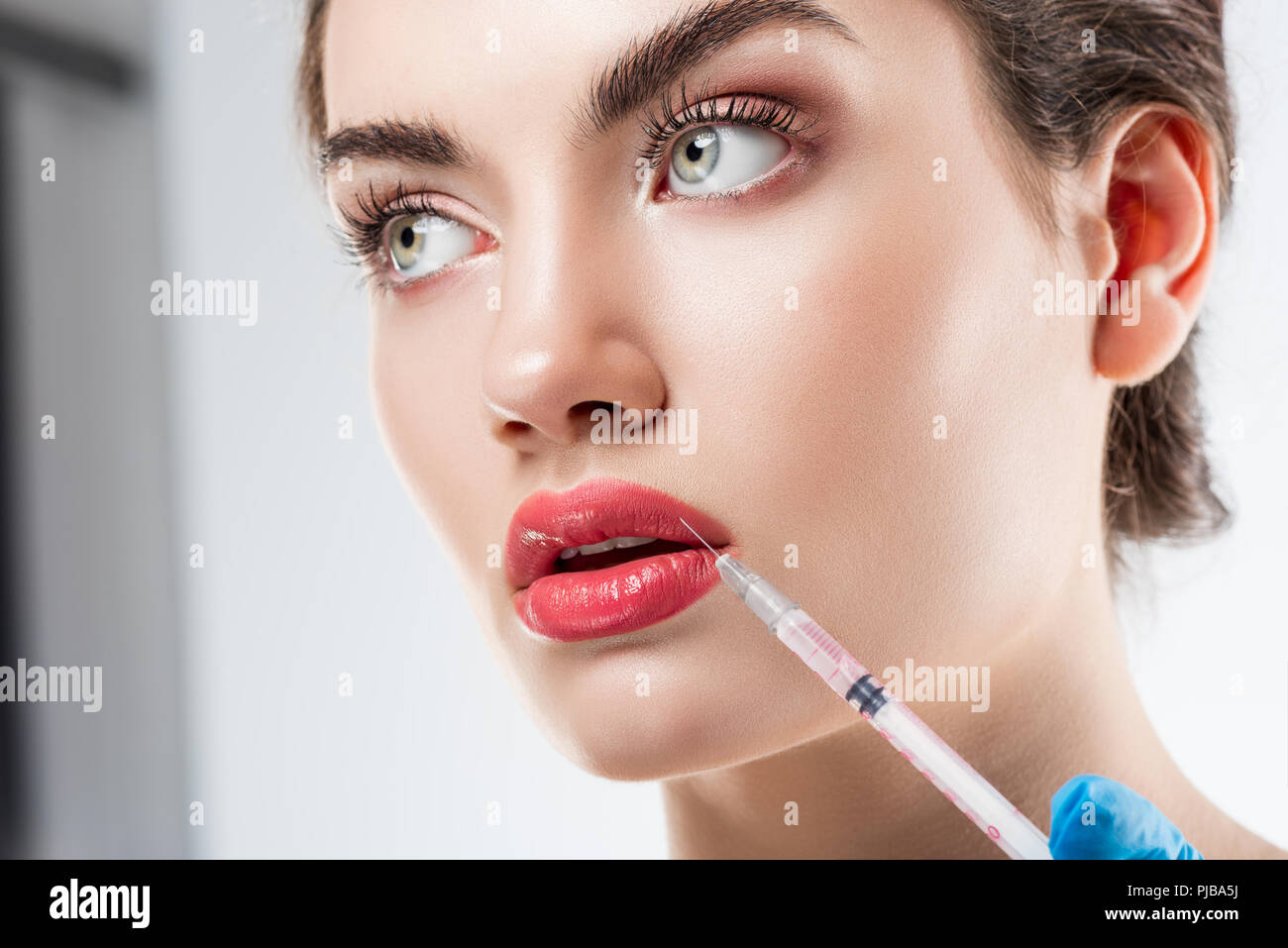 beautiful woman making beauty injection in lips Stock Photo - Alamy