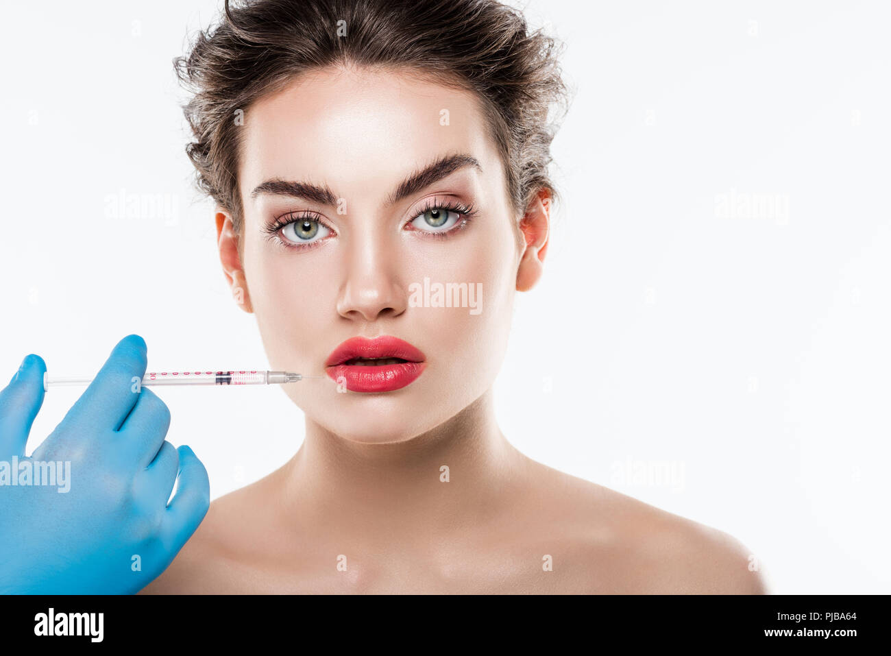 attractive woman making beauty injection in lips, isolated on white ...