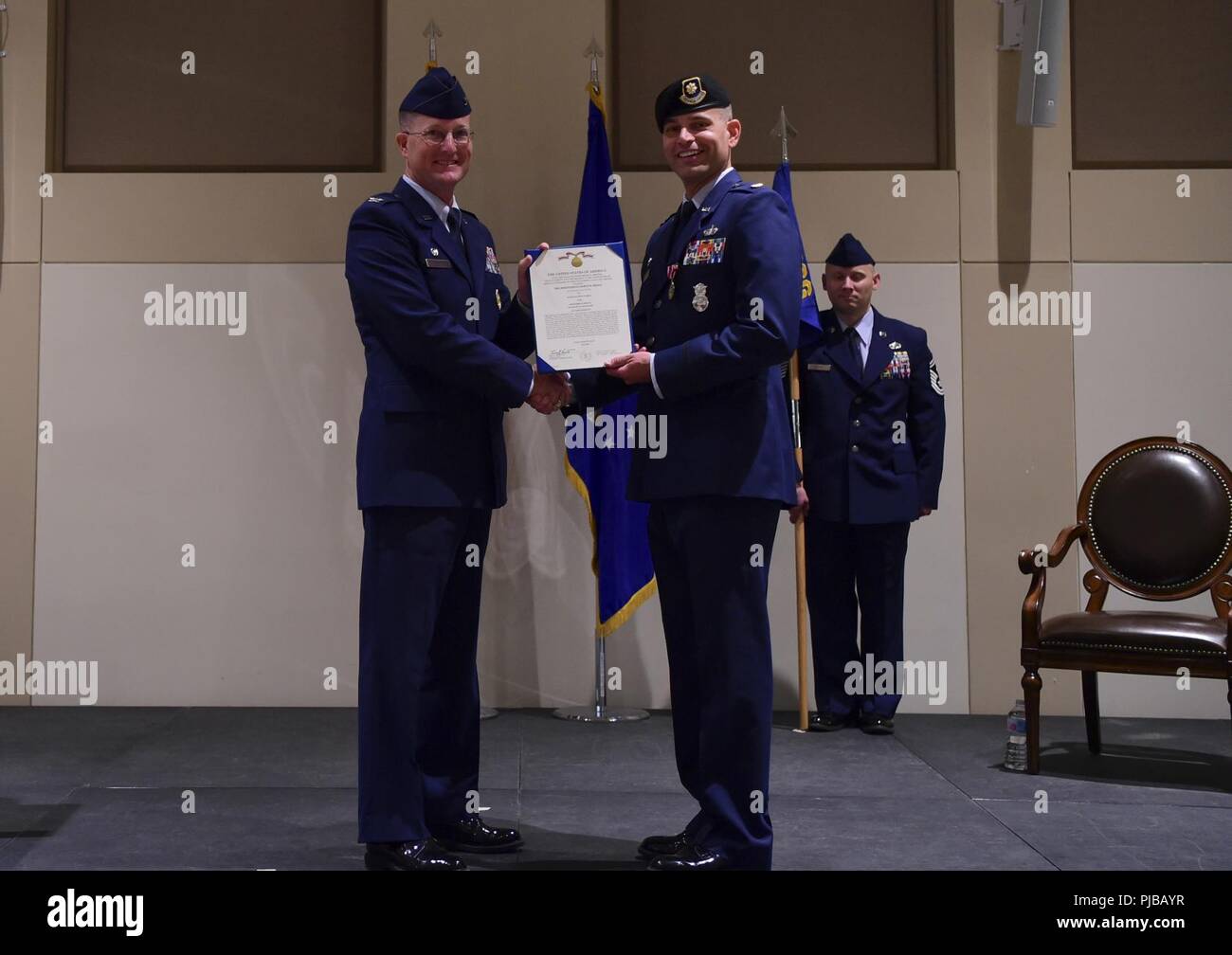 Col. Shawn Thompson, 460th Mission Support Group commander, presents ...