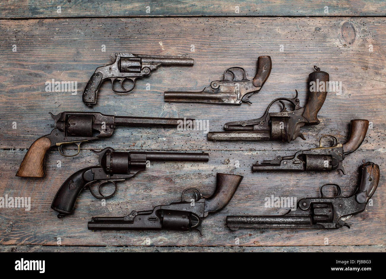 High resolution image of historical guns and pistols on a vintage wood ...