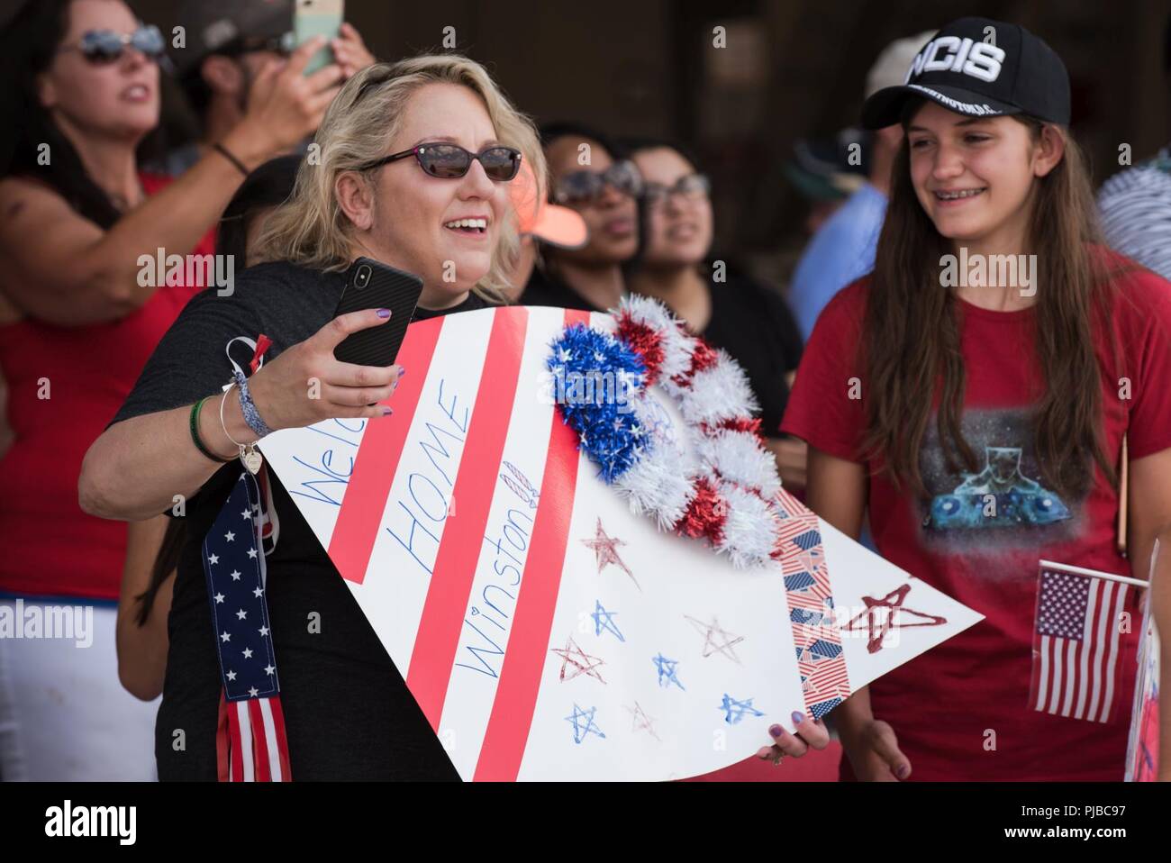 Teresa Pike (left) cheers for her husband, Master Sgt. Winston Pike ...