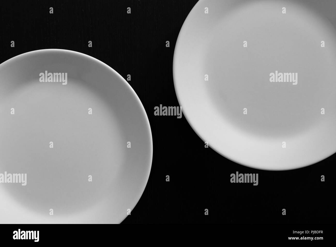 White plates on black Black and White Stock Photos & Images - Alamy