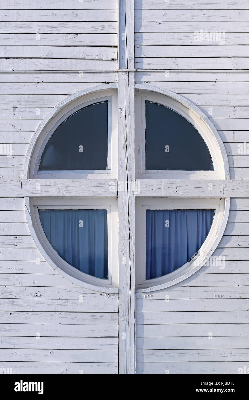 Round cross window at white wood cabin house Stock Photo - Alamy