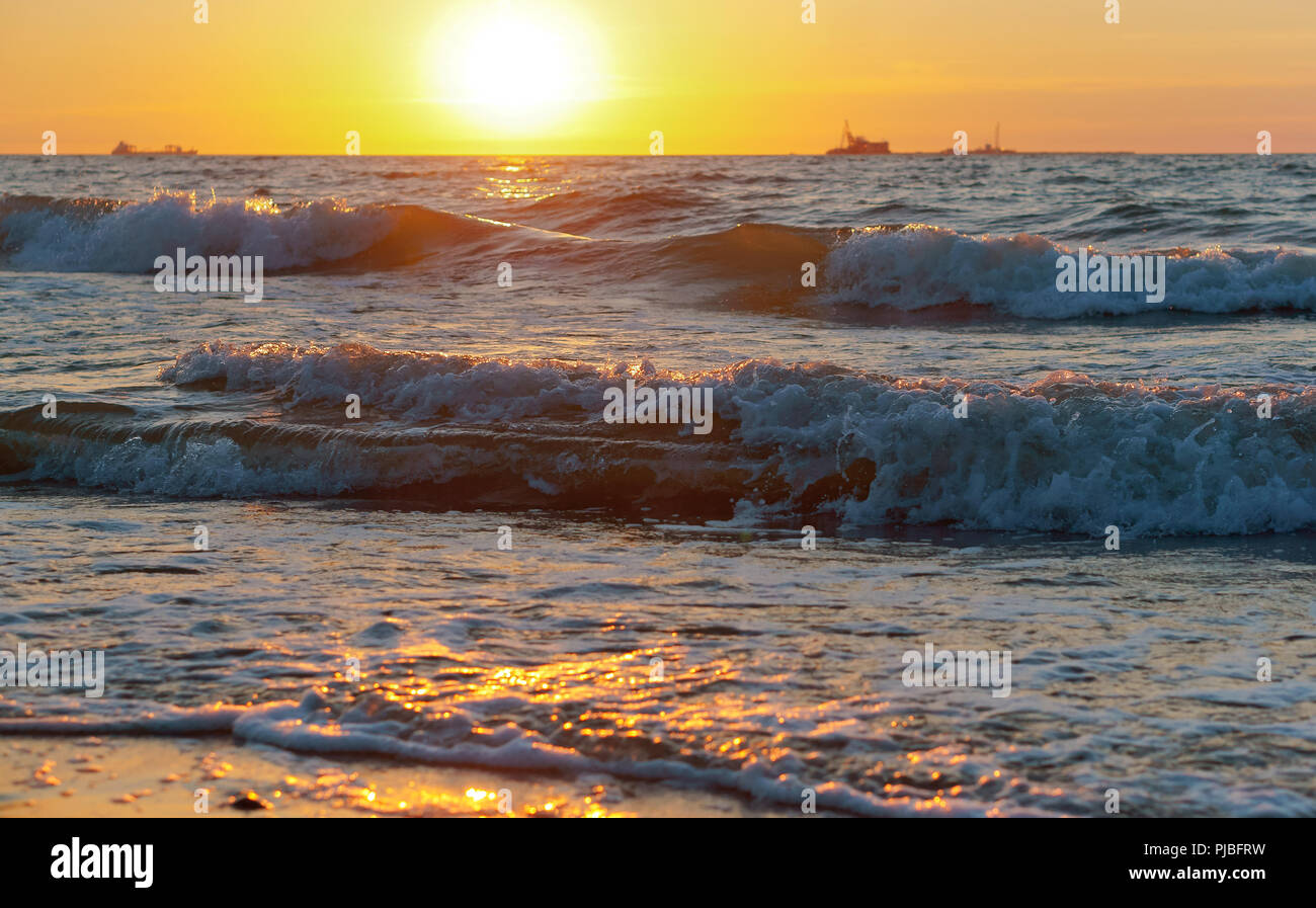 Sunset over the sea. Reflection of sunlight in the sea waves. Red sky ...