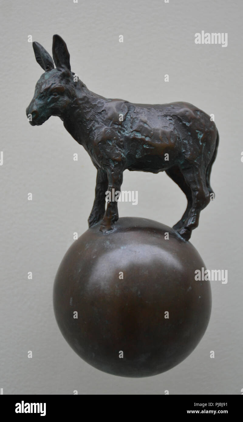 Old metal door handle made as small donkey statue Stock Photo - Alamy