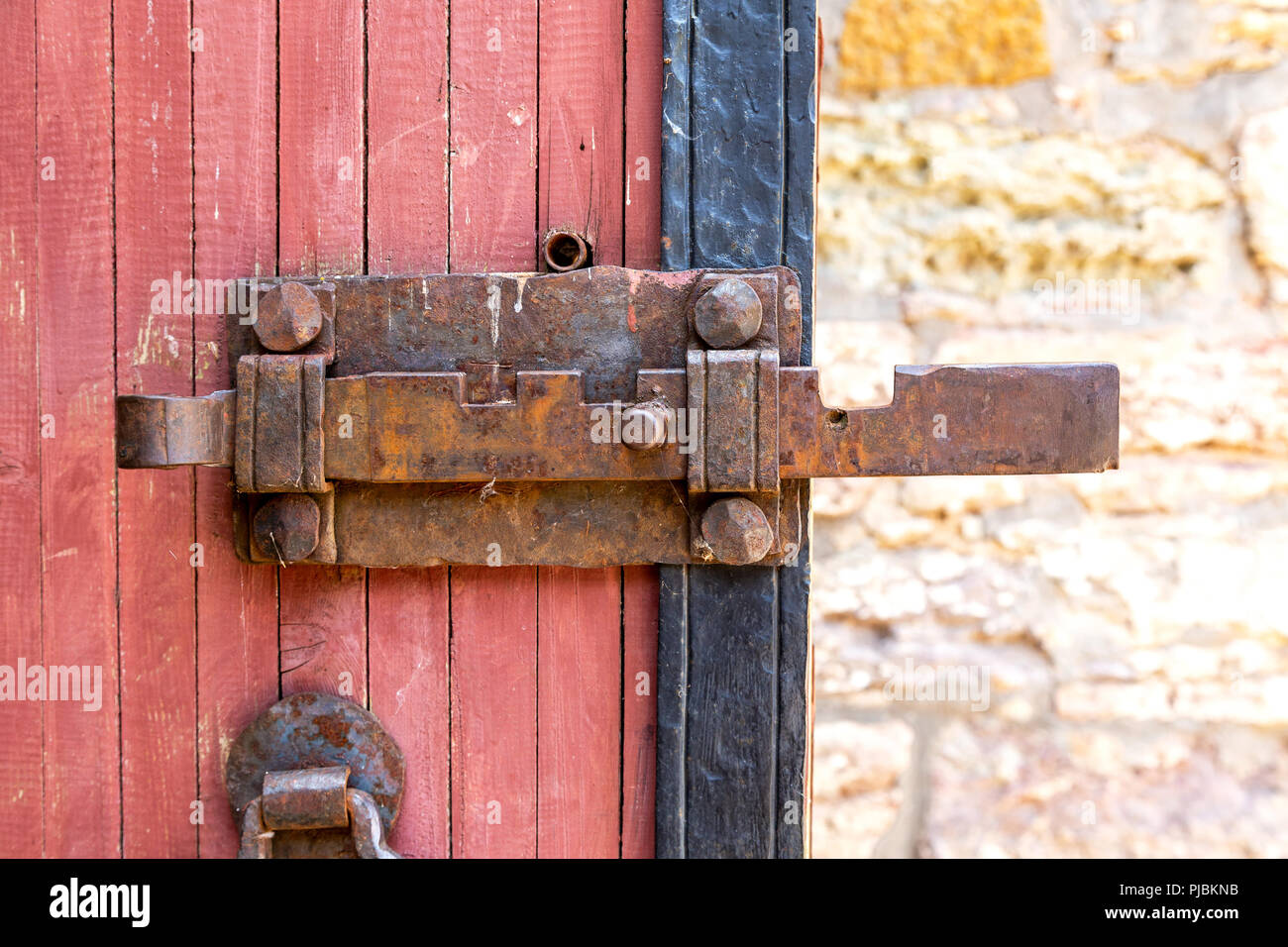 Antique rusty forged massive metal door lock Stock Photo - Alamy