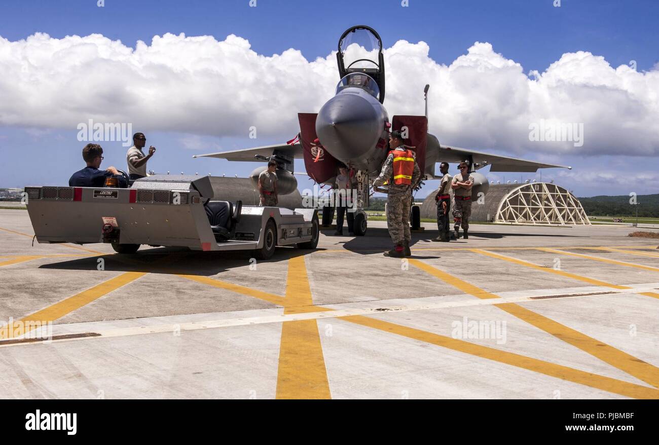 Maintainers from the 18th Aircraft Maintenance Squadron, drive an ...