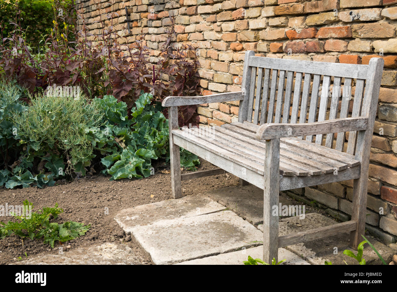 Bench in front of brick house hi-res stock photography and images - Alamy