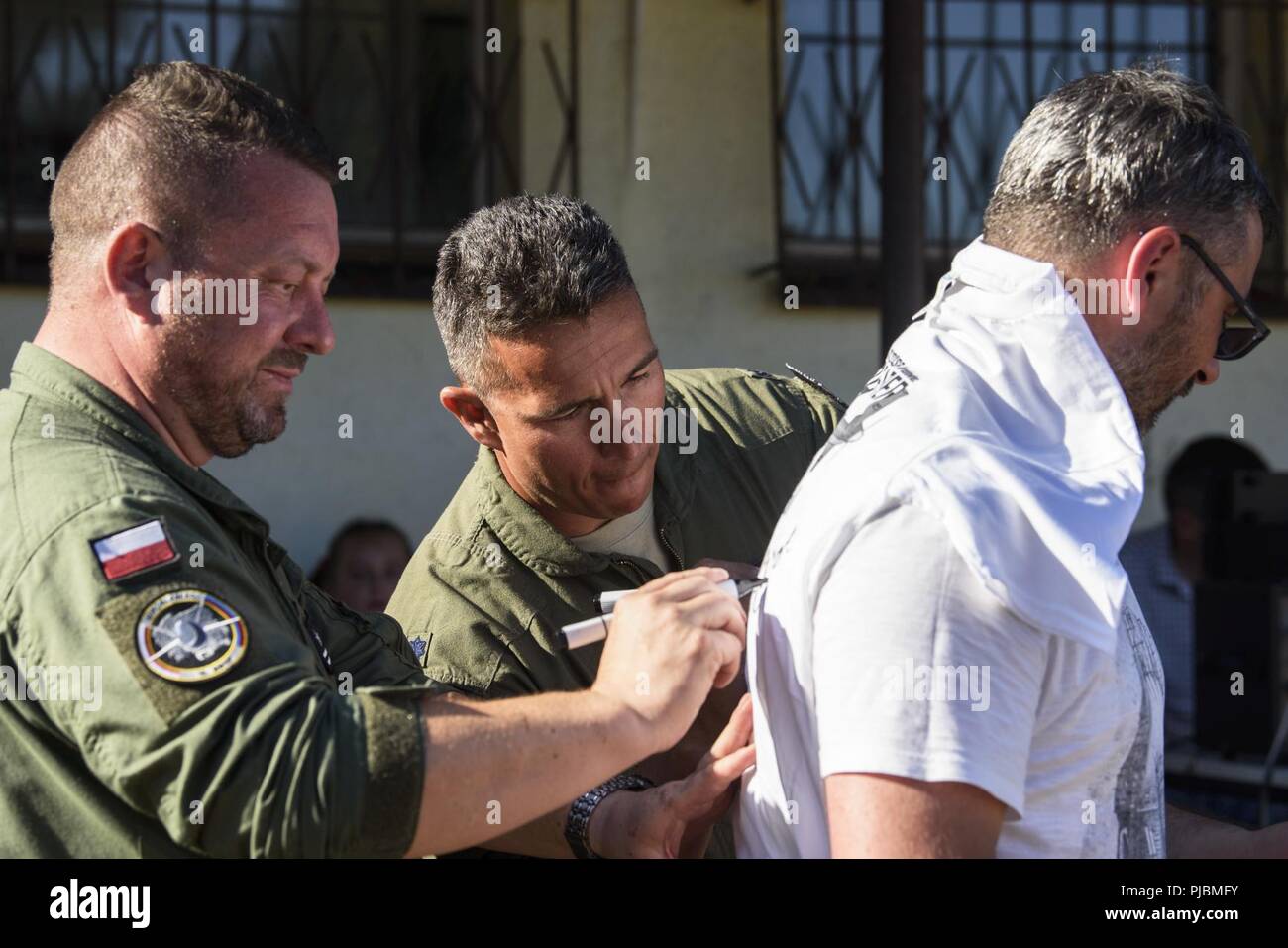 U.S. Air Force Lt. Col. John Jimenez, center, 52nd Expeditionary ...