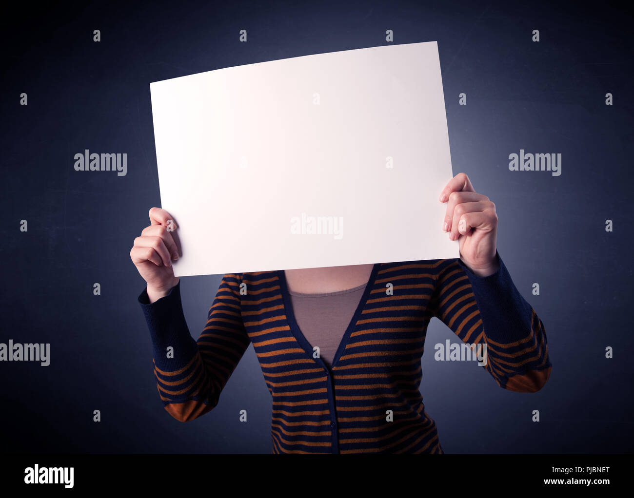Young woman holding a4 paper hi-res stock photography and images - Alamy