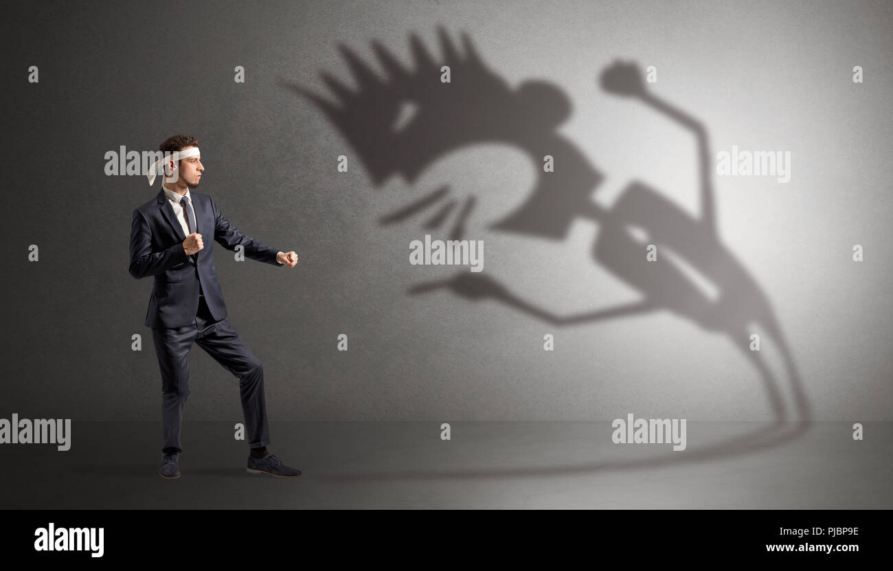 Young karate man fighting with a big black scary shadow Stock Photo - Alamy