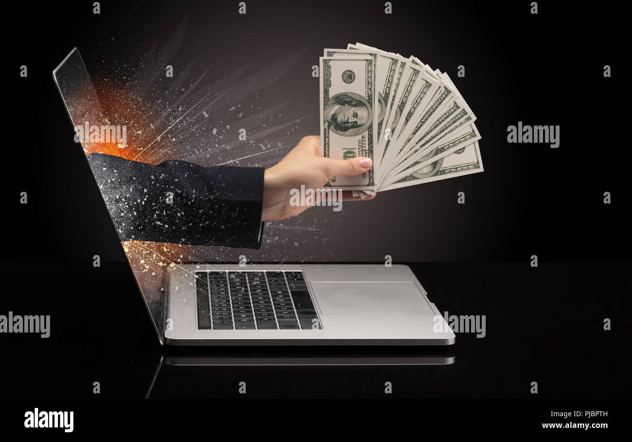 Hand with money coming out of a laptop with sparkling effects Stock ...