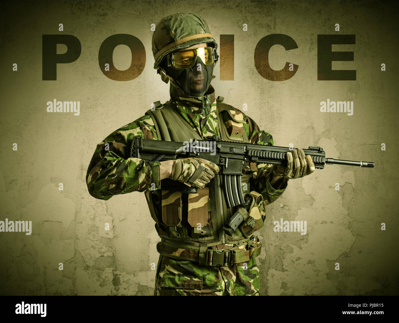 Uniformed armed soldier with damaged wall background Stock Photo - Alamy
