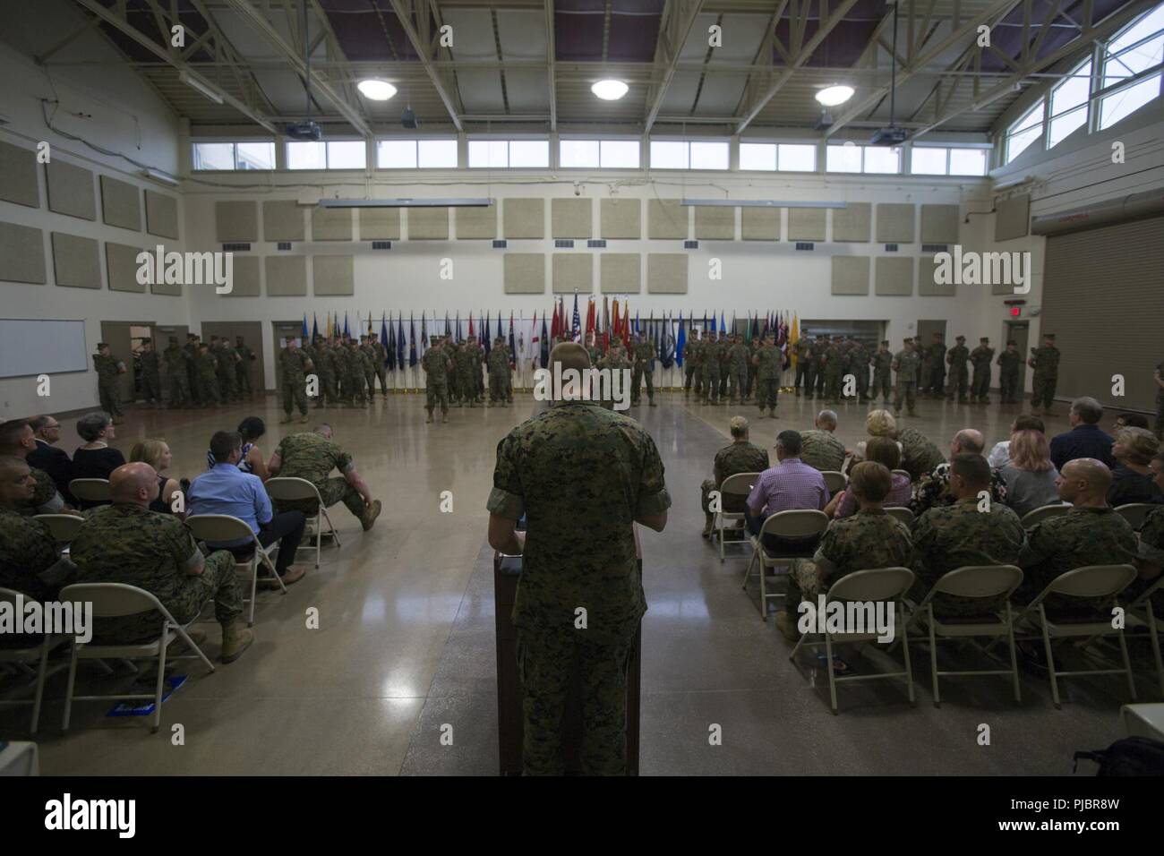 Marines, distinguished guests and visitors take their seats prior to a ...