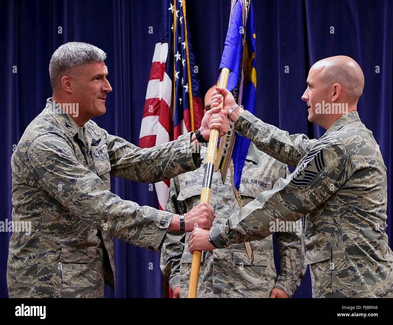 Command Chief Master Sgt. William Horay, right, accepts the guidon of ...